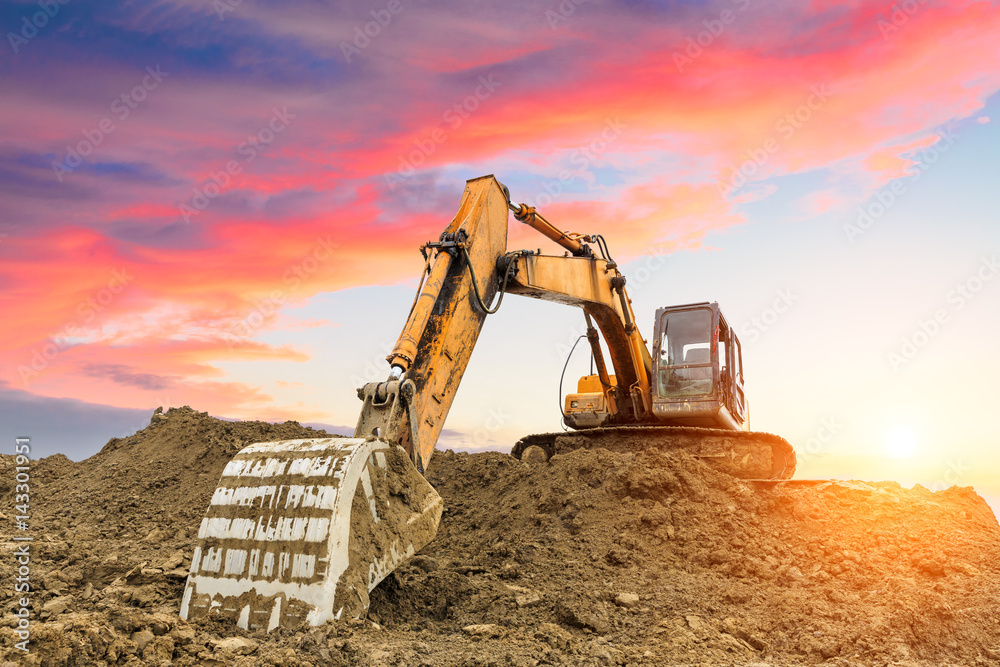 excavator in construction site on sunset sky background Stock Photo ...