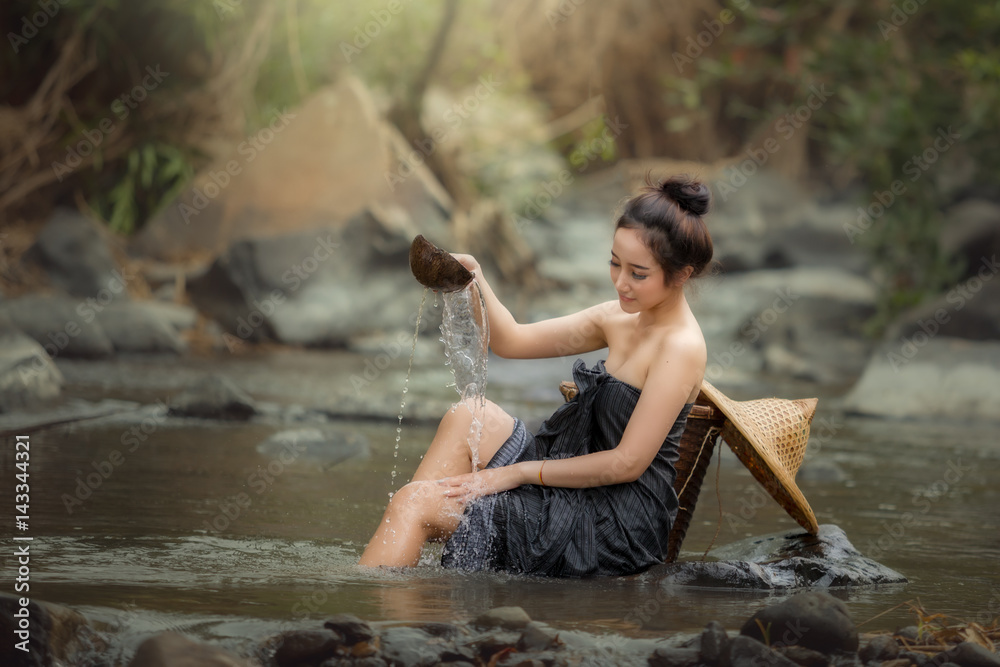 Foto de Women in the shower in nature creek forest enjoy on the river relax do Stock | Adobe Stock