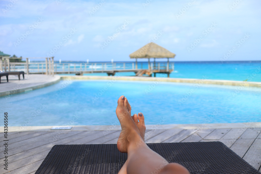 Summer vacation girl lower body closeup. Woman tanning legs relaxing by ...