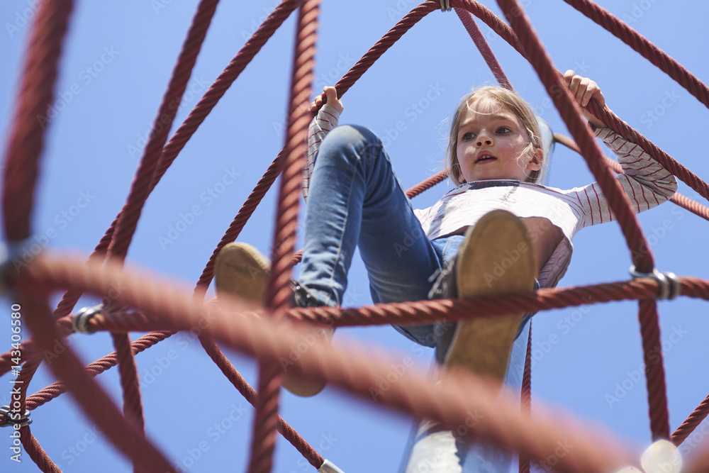 Active young child girl climbing the spider web playground activity ...
