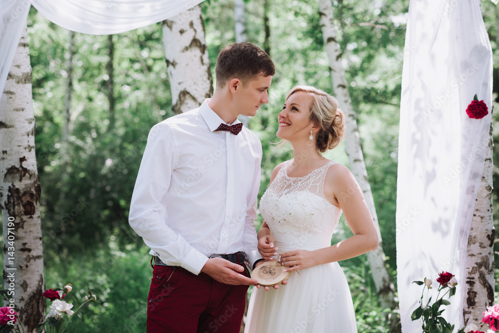 Beauty bride and handsome groom are wearing rings each other. Wedding ...