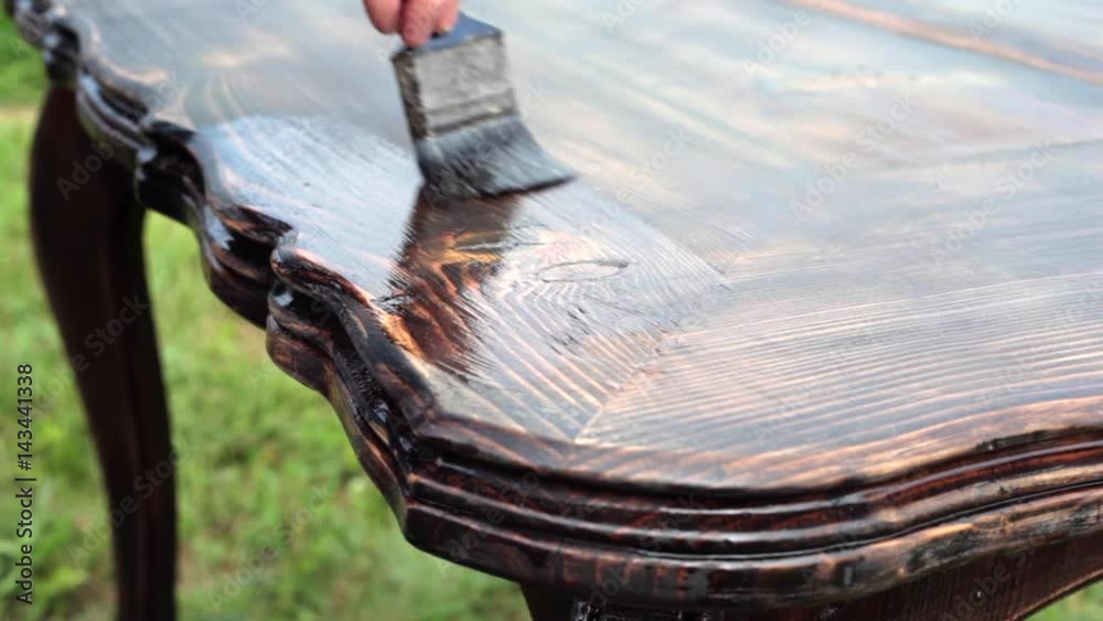 Final Coverage of the Restore Table/The cabinet maker varnishes the ...