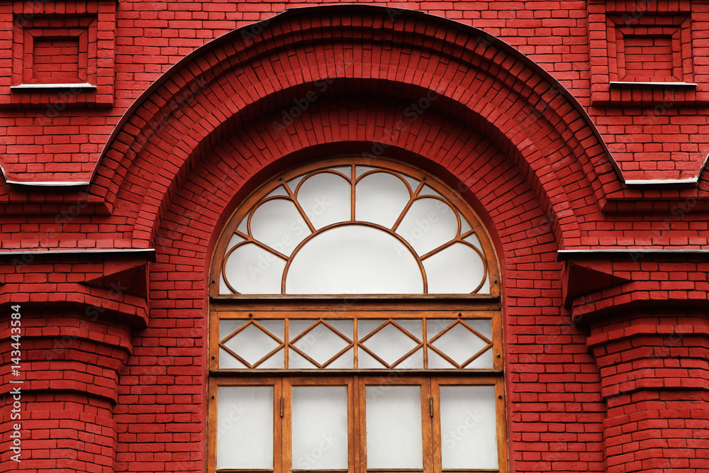 Facade of an old red brick building. A window of unusual shape. Stock ...