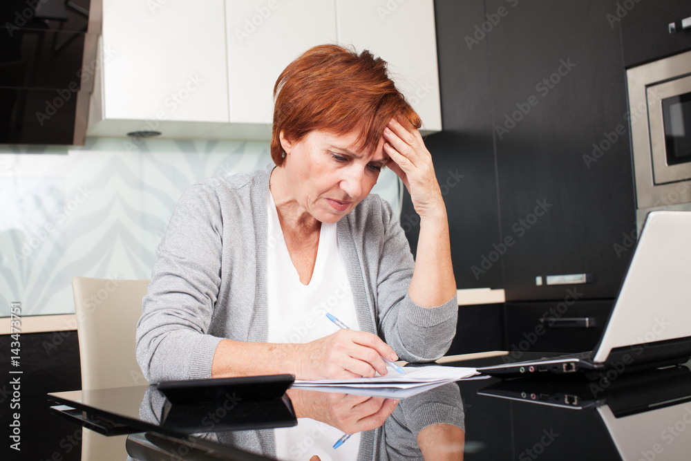 Elderly woman sorting through her old receipts Stock Photo | Adobe Stock