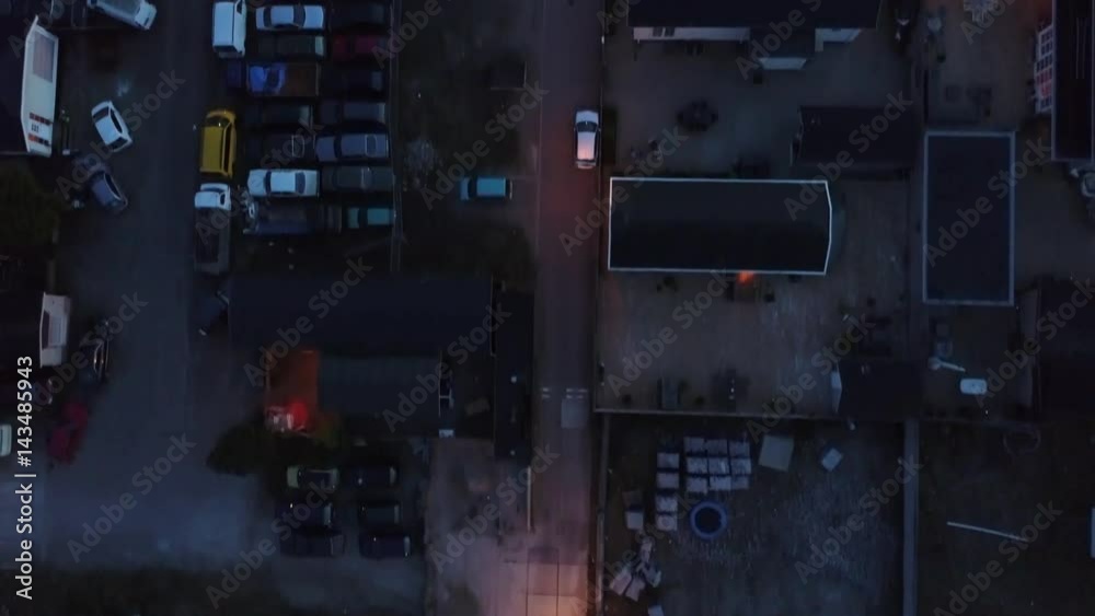 Aerial top down view night flight over ghetto part of city in which ...