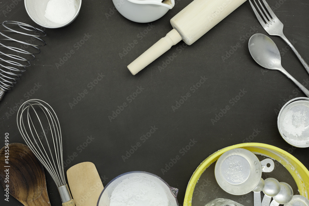 Cooking background with flour sprinkled different kitchen tools on dark ...