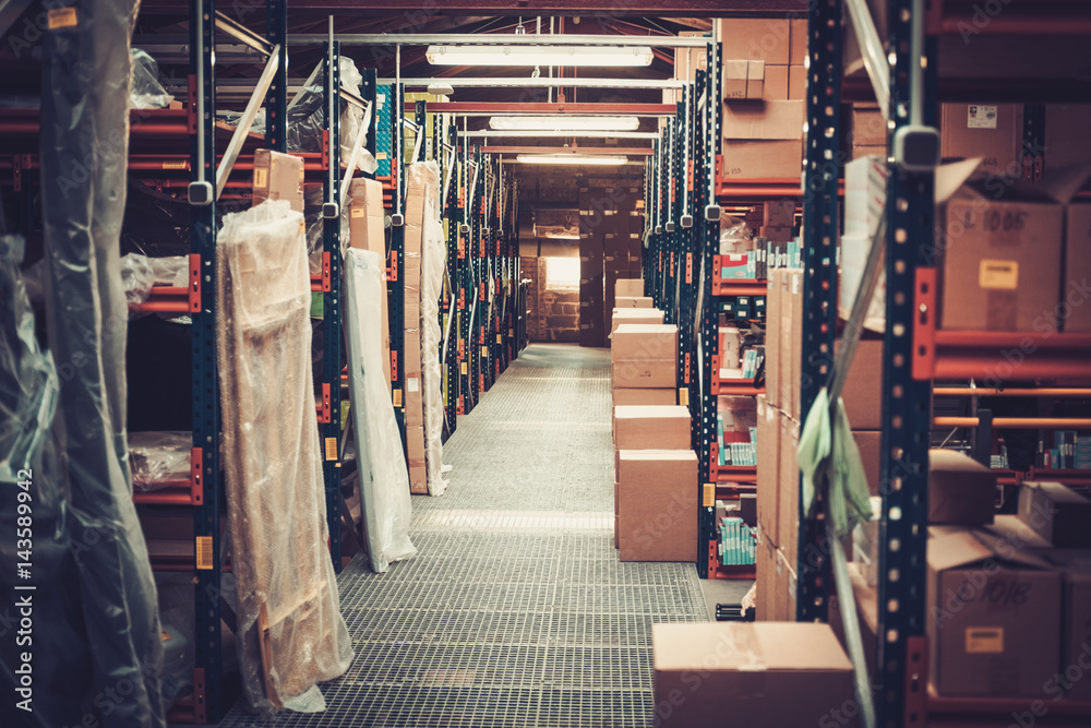 Crates and boxes on a shelves in a warehouse Stock Photo | Adobe Stock