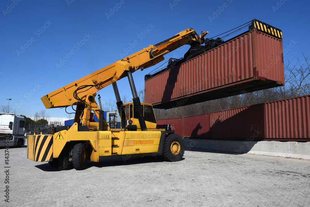 Container handling vehicle maneuvering with load Stock Photo | Adobe Stock