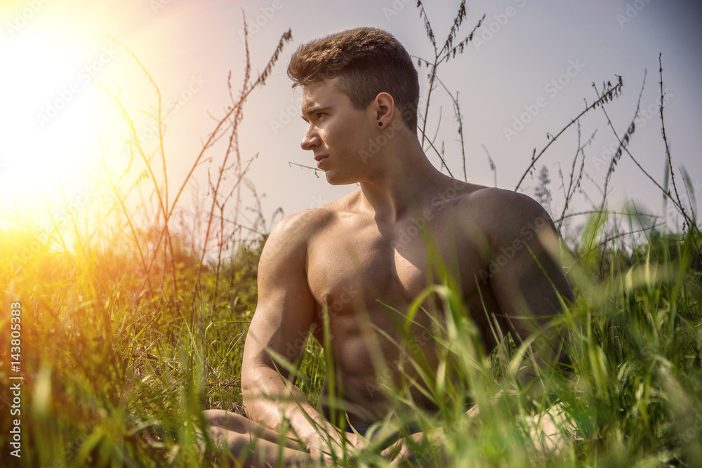 Handsome Muscular Shirtless Young Hunk Man Outdoor in Nature Sitting on ...