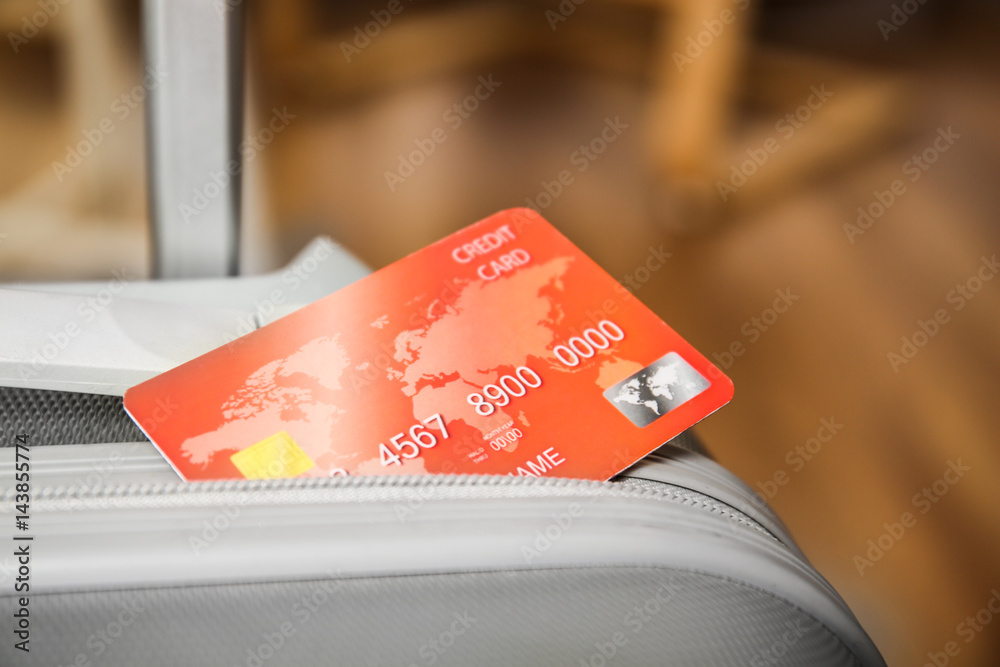 Credit card in suitcase on blurred background Stock Photo | Adobe Stock