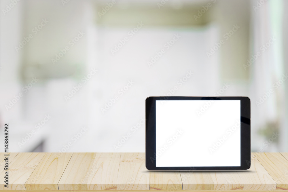 Tablet Showing blank screen on wood table in bath room. for product and ...