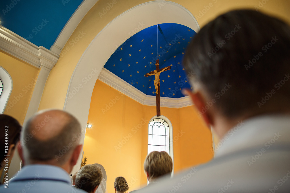 Religion concept. People looking at cross with Jesus Christ in church ...
