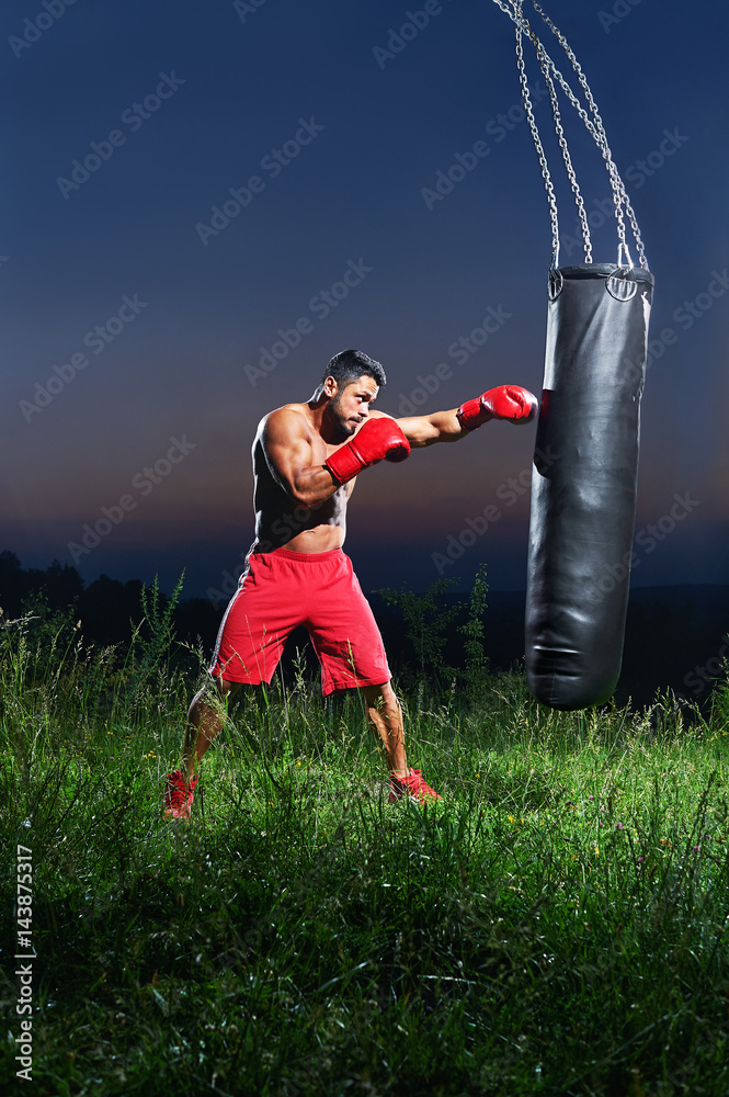 Vertical shot of a shirtless boxer with strong ripped muscular body ...