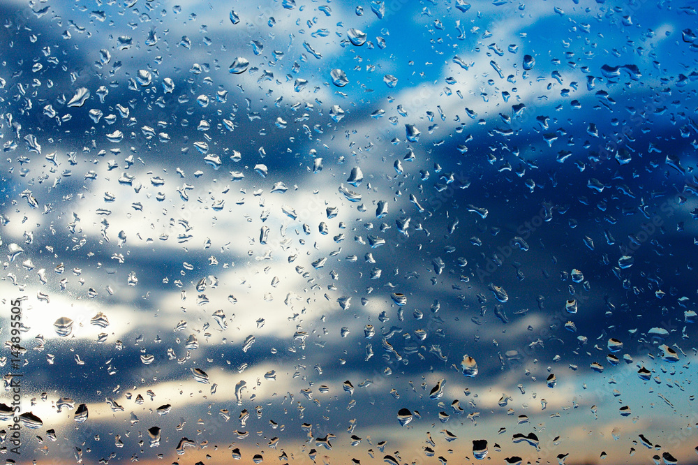 Textures of water droplets of rain flow down the windowpane ...