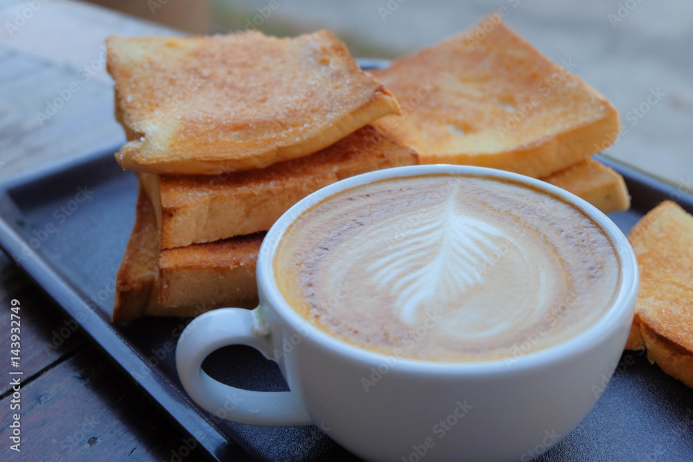 A cup of coffee with bread on wooden background Stock Photo | Adobe Stock