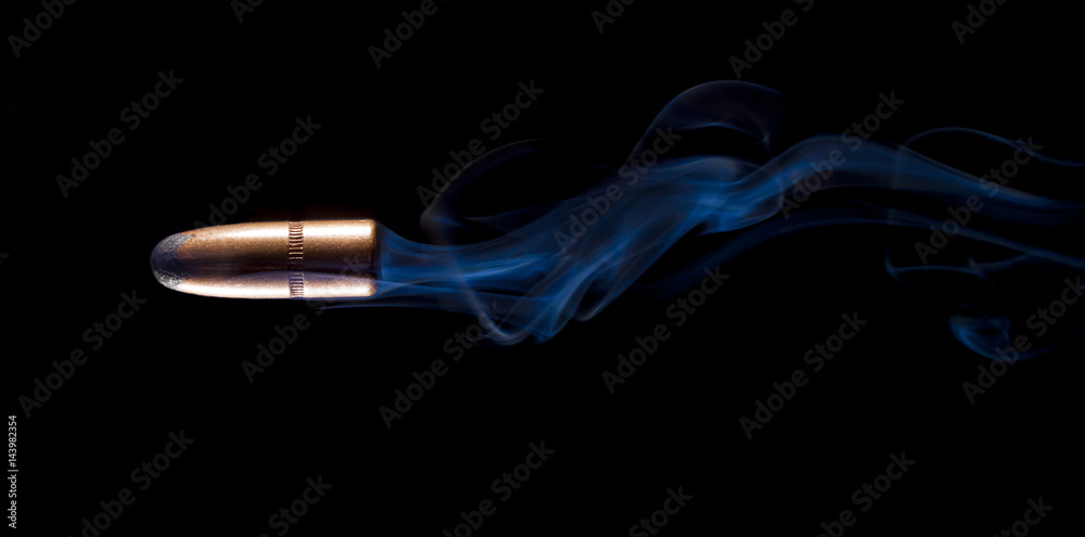 Copper bullet that looks like it is flying Stock Photo | Adobe Stock