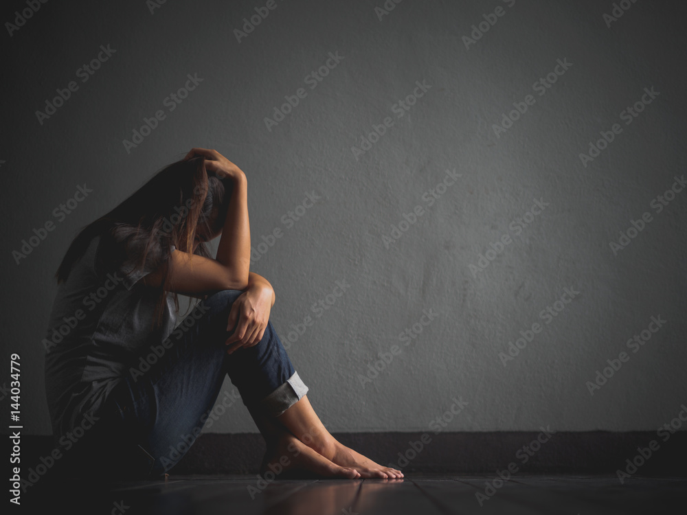 sad woman hug her knee and cry. Sad woman sitting alone in a empty room ...