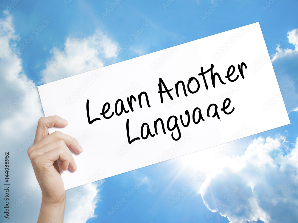 Learn Another Language Sign on white paper. Man Hand Holding Paper with ...