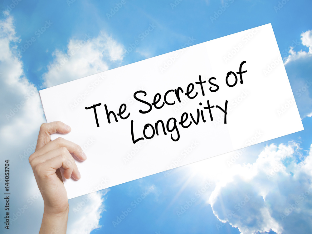 The Secrets of Longevity Sign on white paper. Man Hand Holding Paper ...