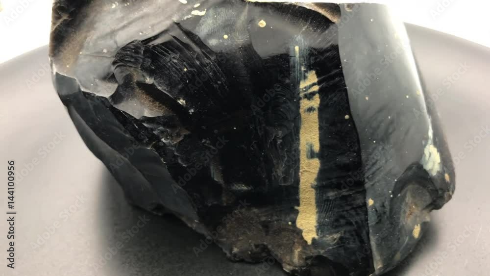 Rotating big piece of black Obsidian, a natural volcanic glass with ...