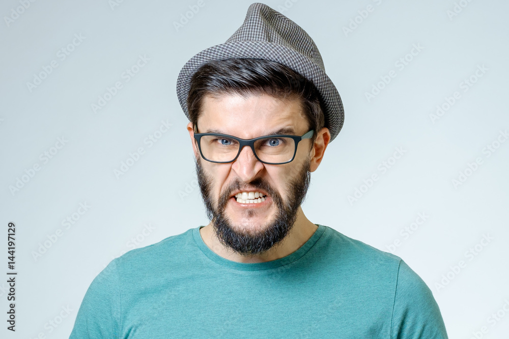 Angry and furious male on a gray background Stock Photo | Adobe Stock