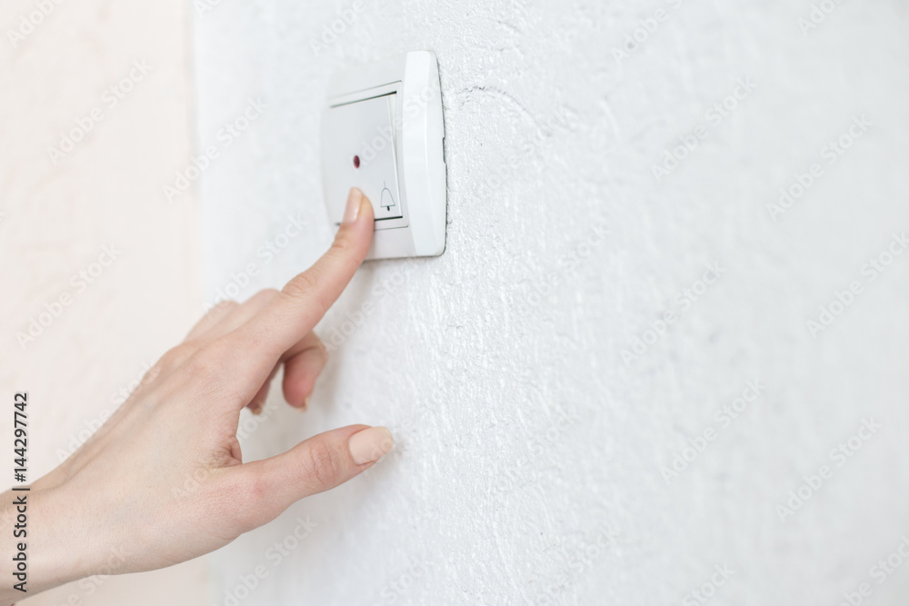 Woman pressing doorbell. Close up of a hand ringing at door Stock Photo ...