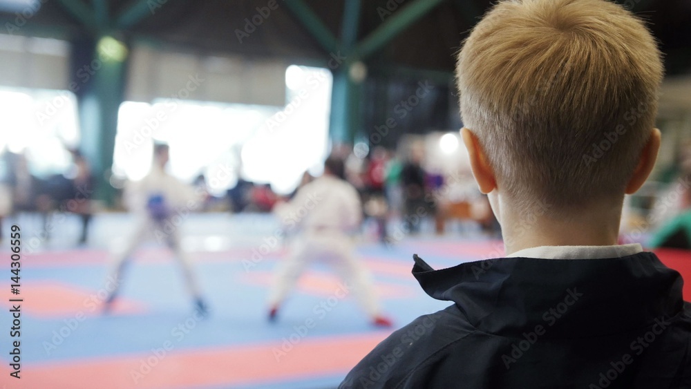 Karate championship - teenager boy looking at karate fighting ...