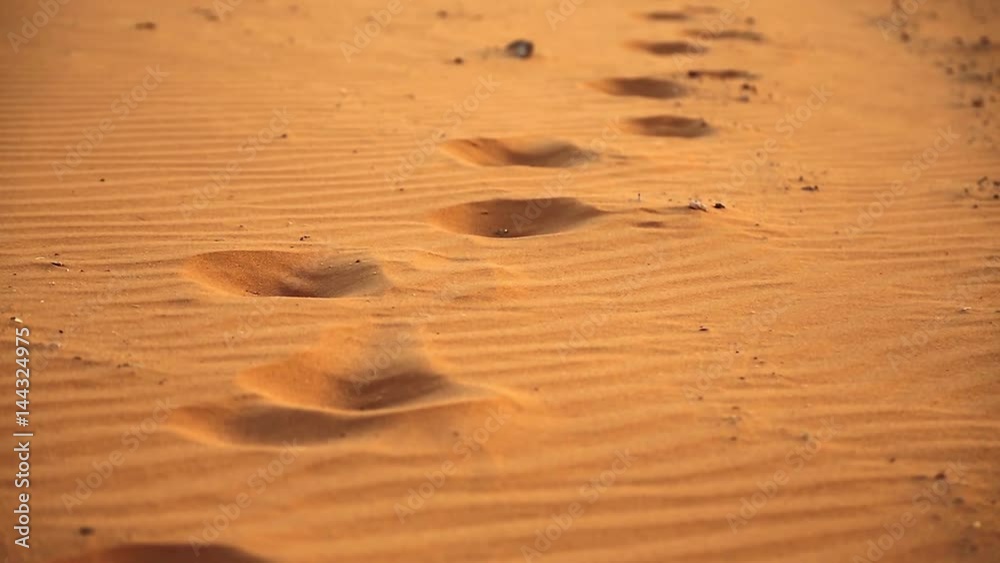 Footprints on the yellow sand in Wadi Rum desert, also known as The ...