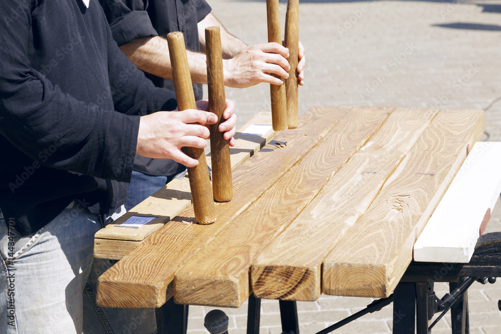 Txalaparta outdoors, in a sunny day. The txalaparta is a percussion ...