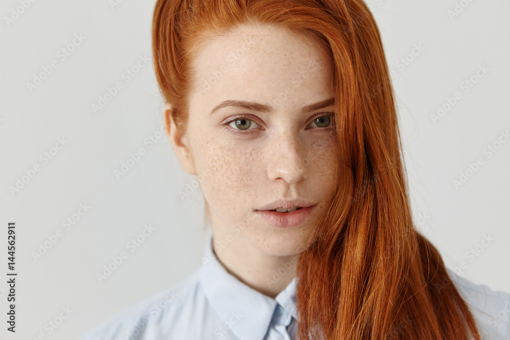 Beautiful ginger girl with freckles all over her pretty face standing ...
