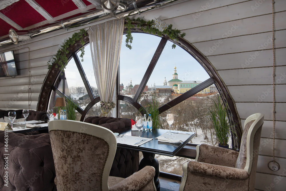 Table with a bar in the restaurant with panoramic windows. Elegant ...