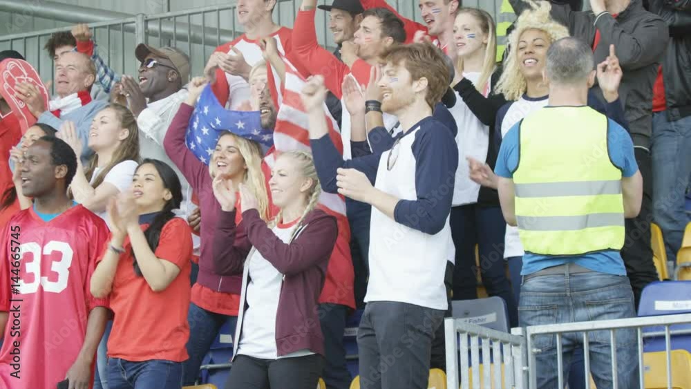 Excited fans with US flag in sports crowd, clapping & cheering on their ...