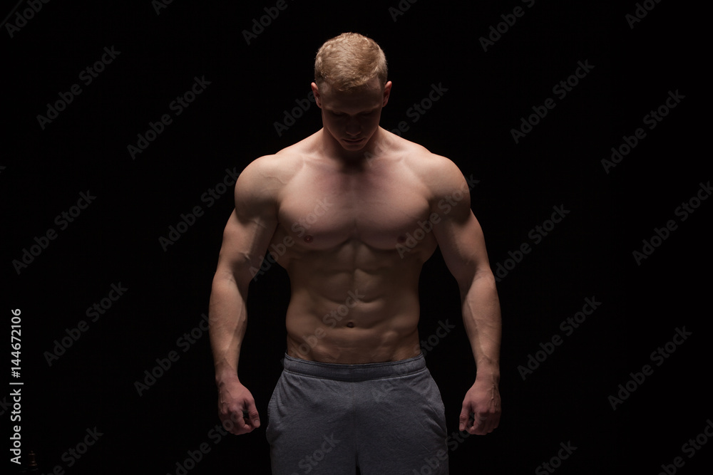 Athletic handsome man fitness-model is showing six pack abs. isolated ...