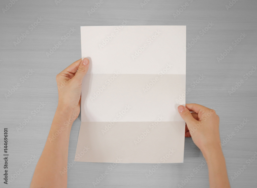 Hands holding blank white brochure booklet in the hand. Leaflet ...