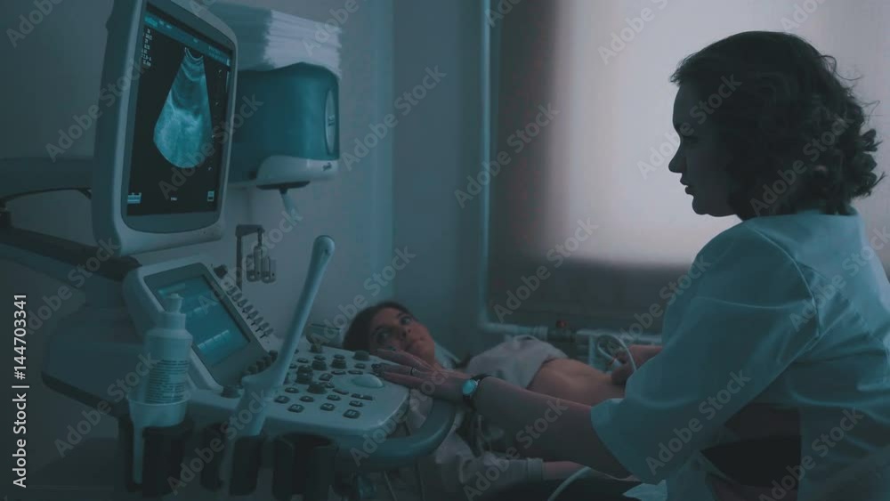 Ultrasound machine doctor s hand usg investigation USCG. Woman getting ...