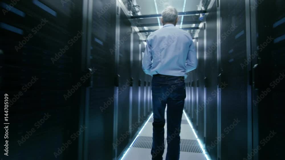 In Data Center IT Engineer Holding Notebook Walks Into Opening Sliding ...