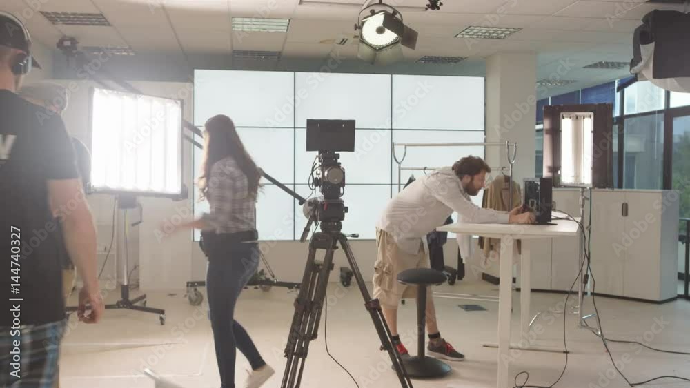 Time lapse of TV crew in studio, setting up for a shoot & packing away ...