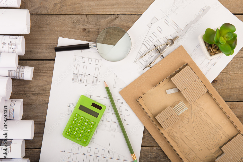 Workplace of architect - construction drawings, scale model and tools ...