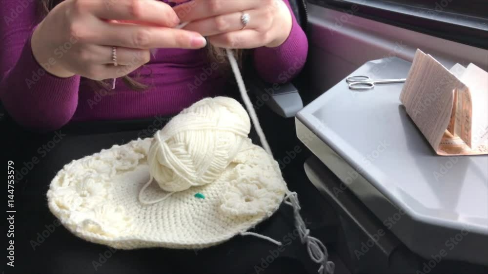 Vídeo do Stock: The girl is engaged in knitting in a train. Sits at the ...