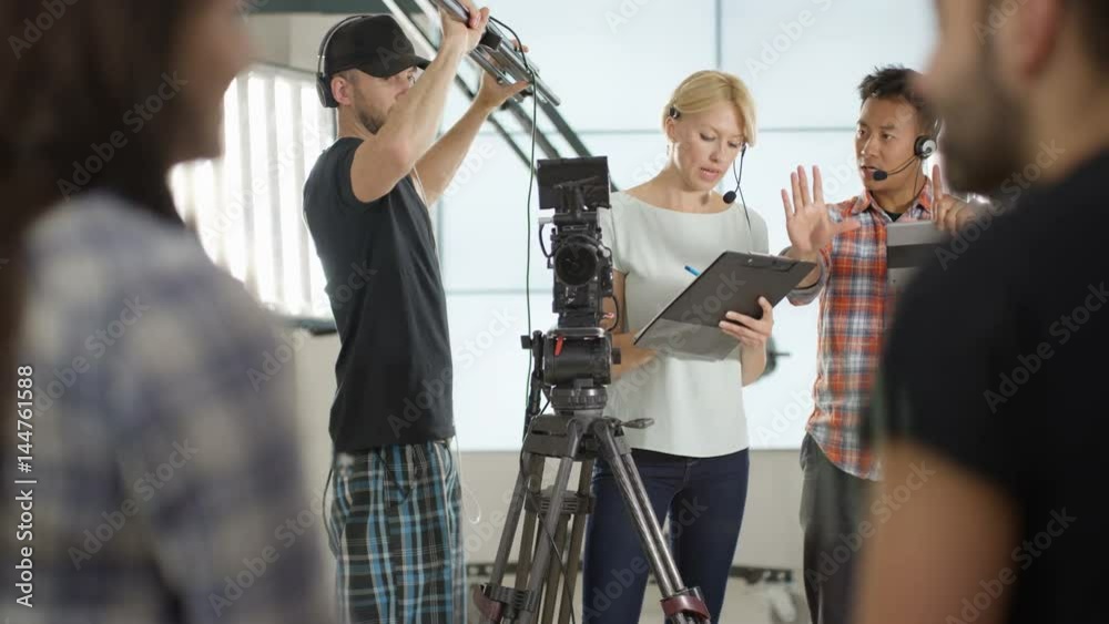 Behind the scenes with TV or film production crew working together on ...