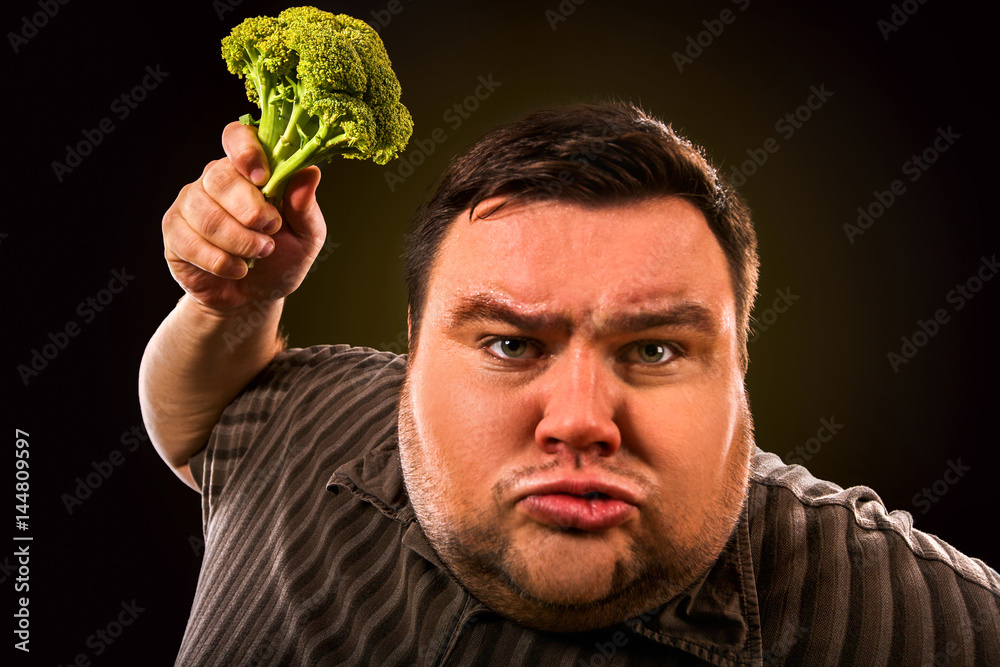 Diet fat man eating healthy food . Health breakfast with vegetables ...