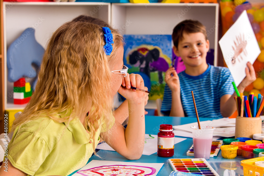 Small students girl and boy painting in art school class. Child drawing ...