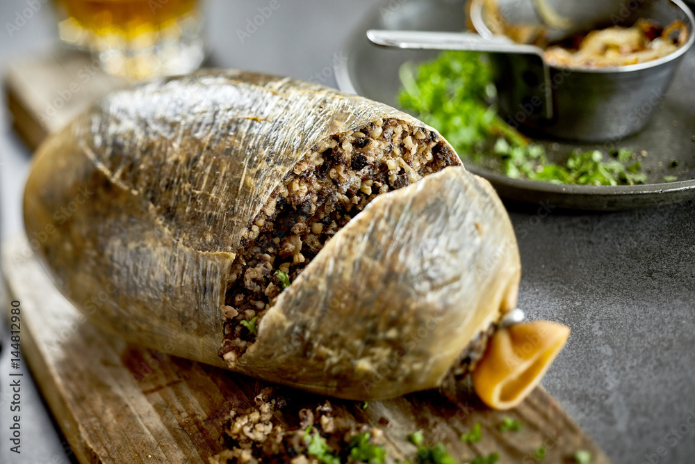 Traditional cooked Scottish haggis with herbs Stock-Foto | Adobe Stock
