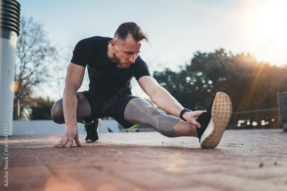 Outdoor Workout lifestyle concept.Young fitness man doing stretch ...