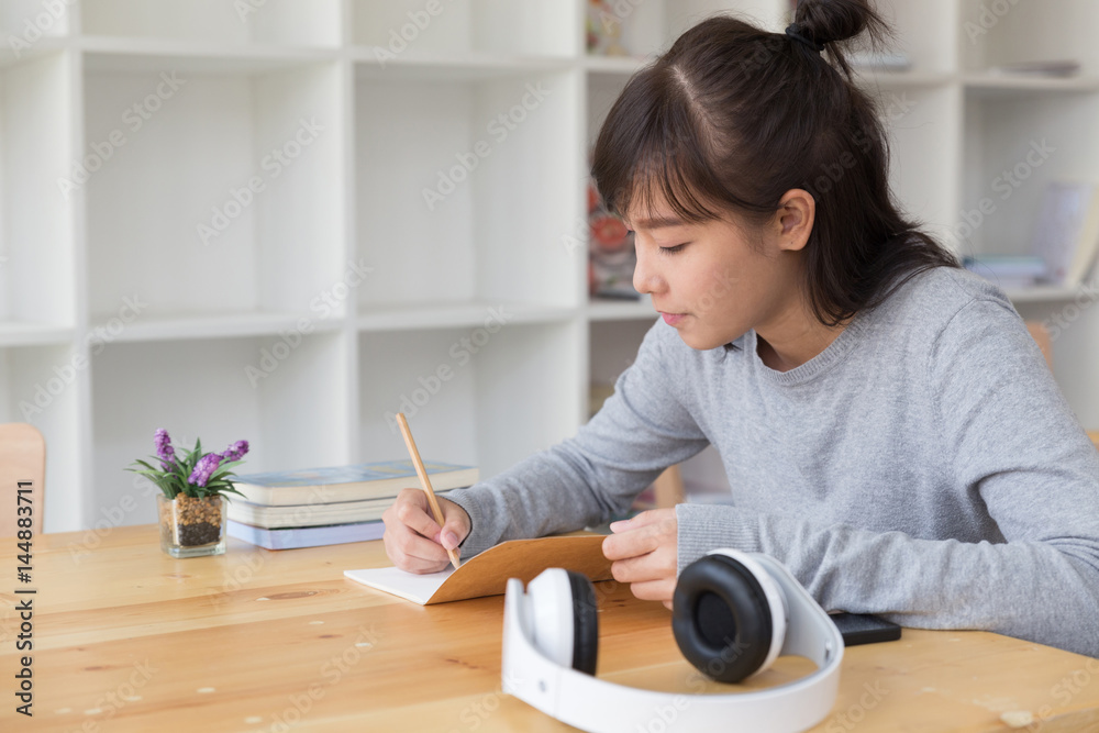 asian girl female teenager studying at school. Student writing note in ...