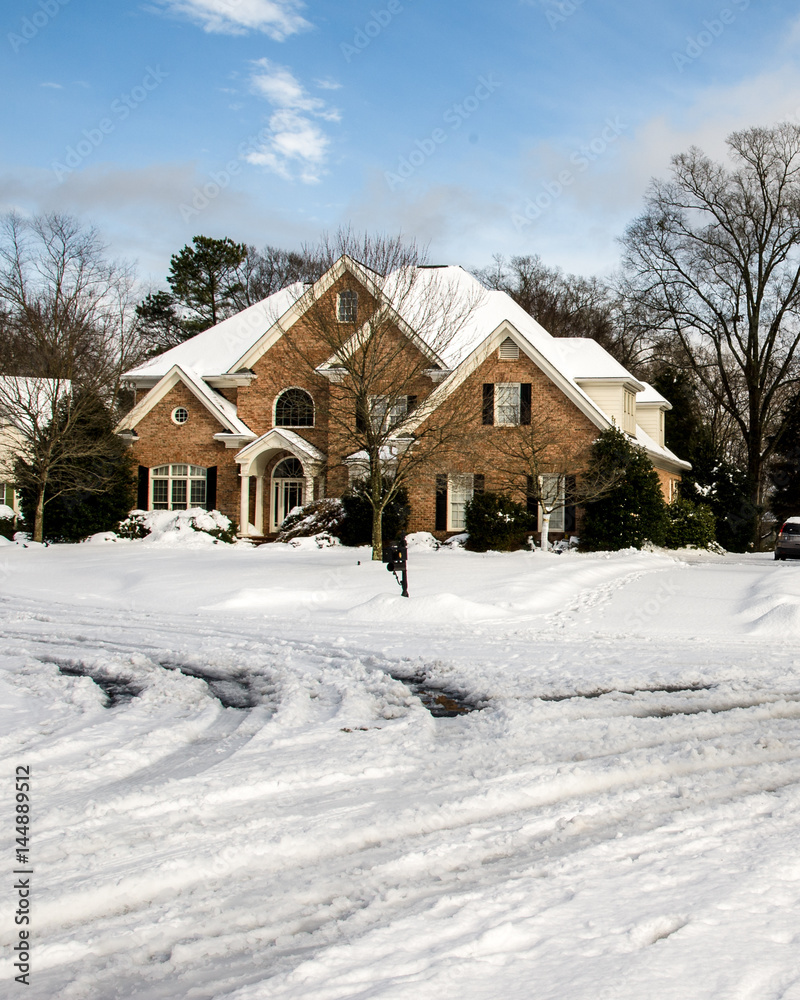Beautiful estate home with snow covered roads Stock Photo | Adobe Stock