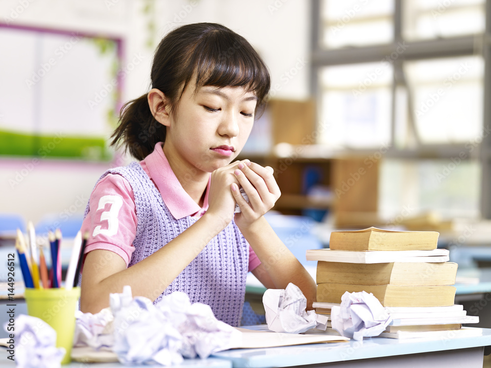 frustrated asian elementary school girl Stock Photo | Adobe Stock