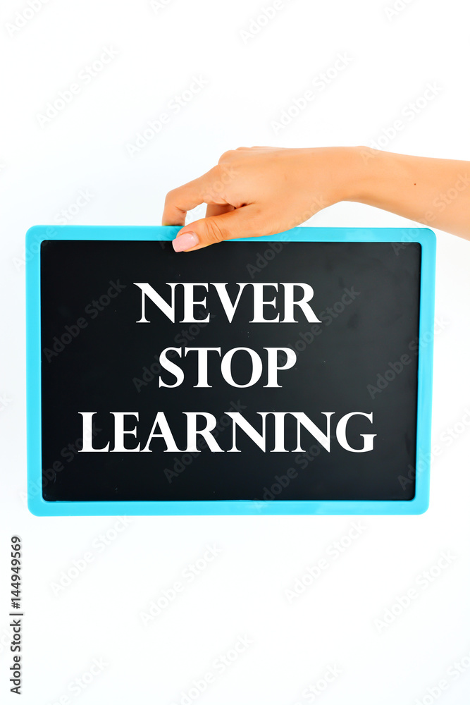 Never stop learning written on small blackboard in woman hand Stock ...
