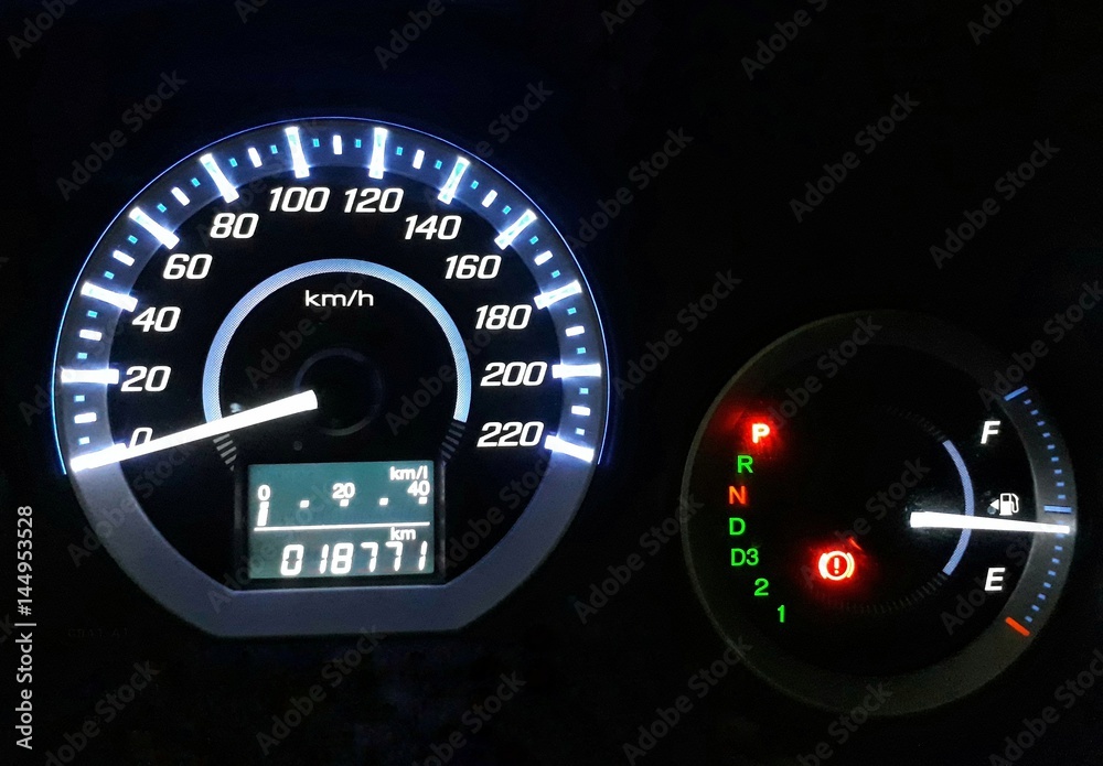 Car console dashboard; speedometer and feul gauge in black background ...