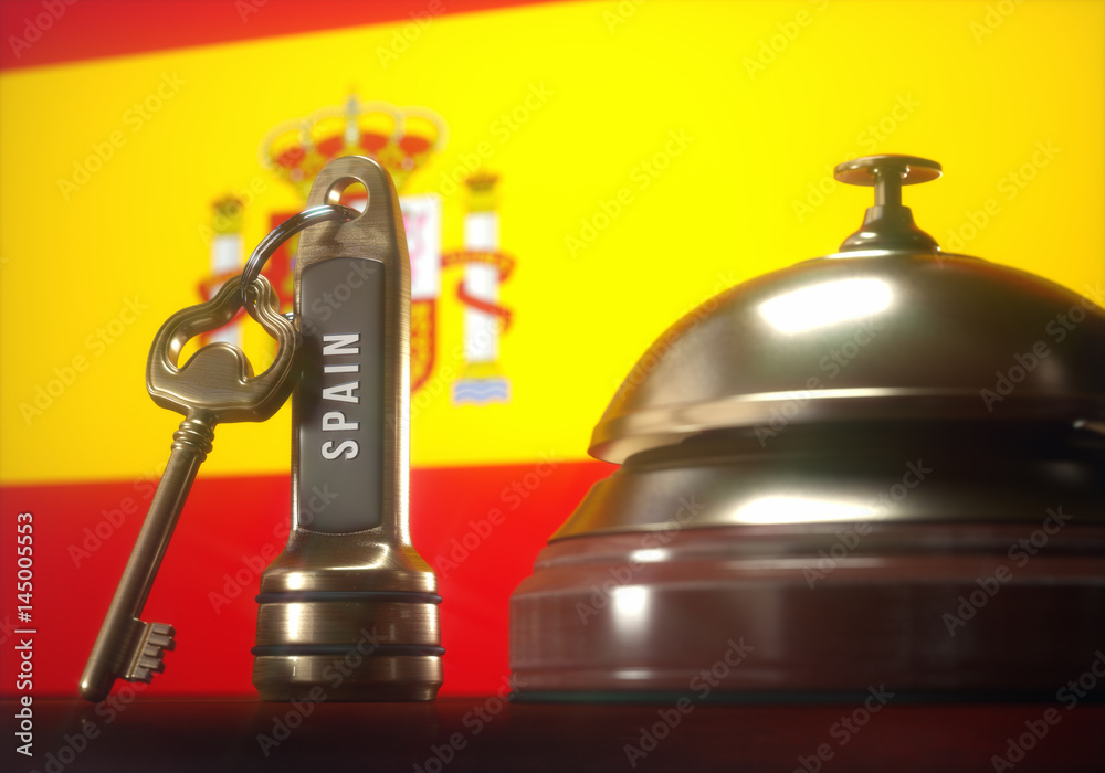 Luxury hotel key and vintage golden bell of the Spain on the wooden ...